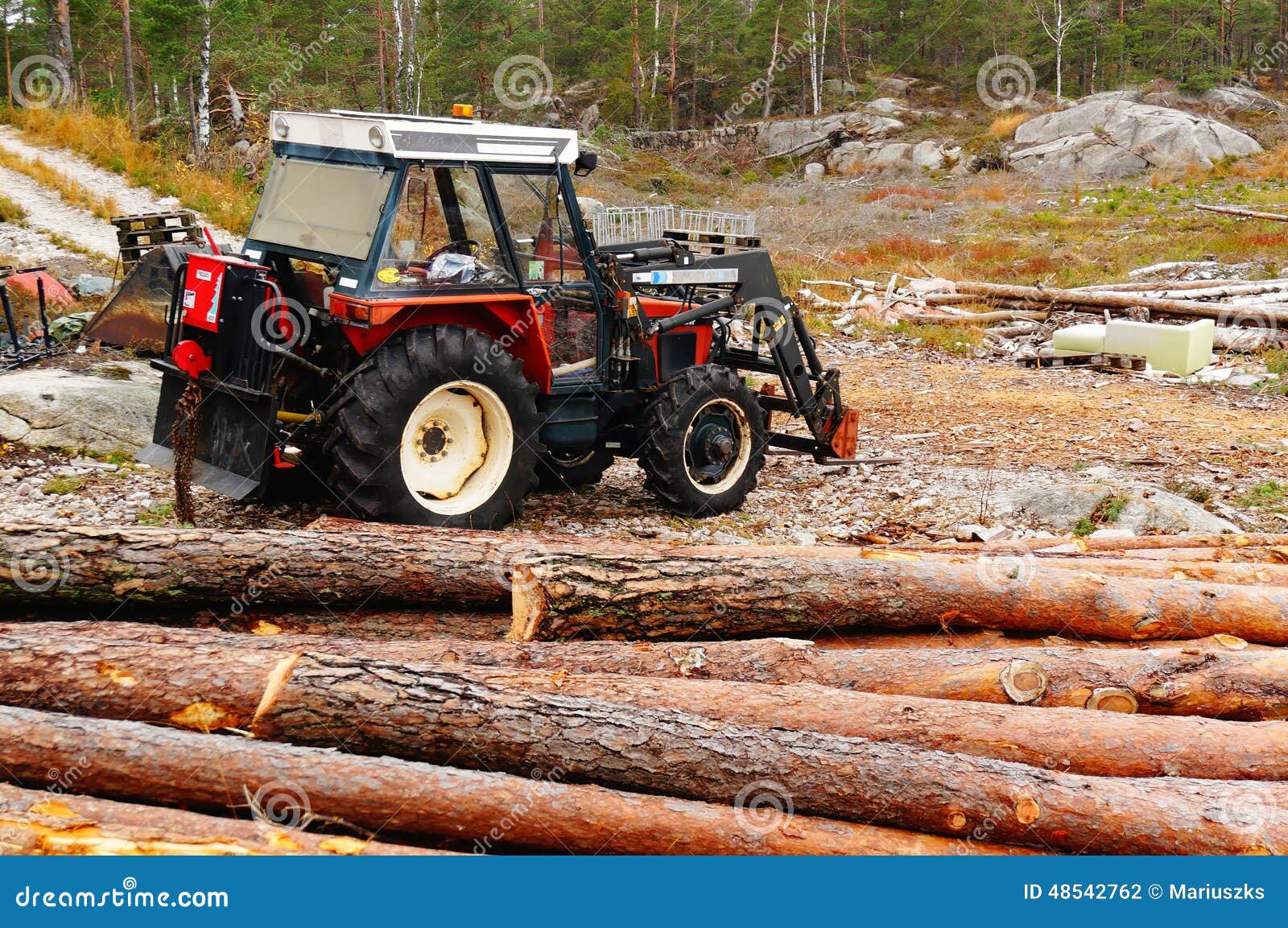 Tractor with felling trees stock photo. Image of wheels - 48542762