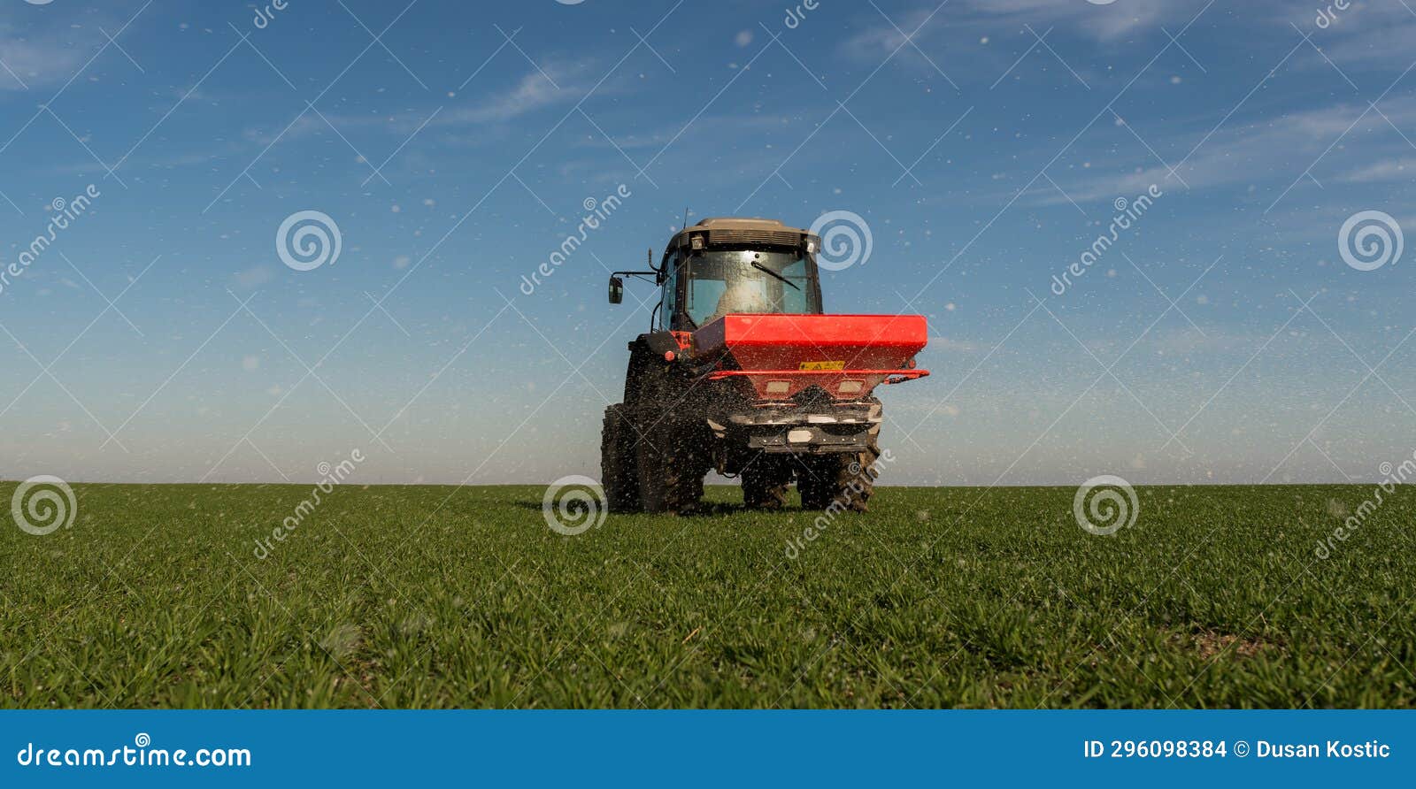 Tractor Fertilizing in Field Stock Photo - Image of field, equipment ...