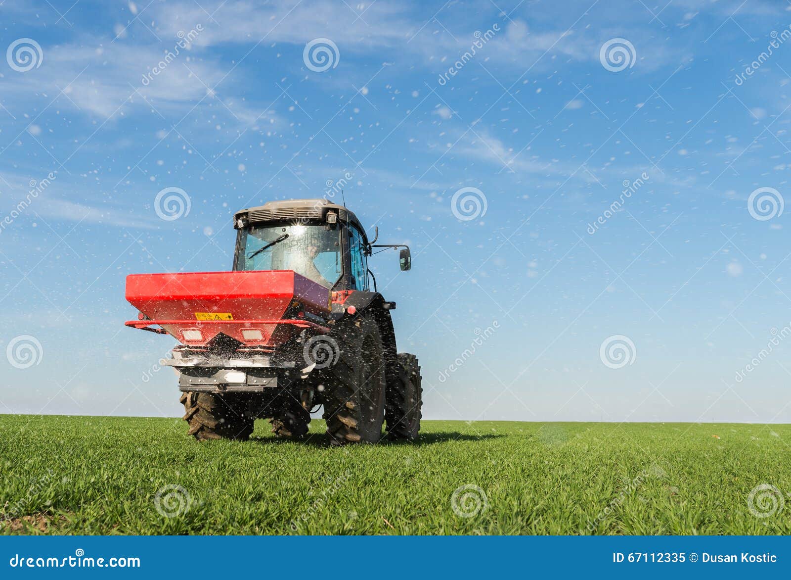 Tractor Fertilizing in Field Stock Image - Image of farmland, tractor ...