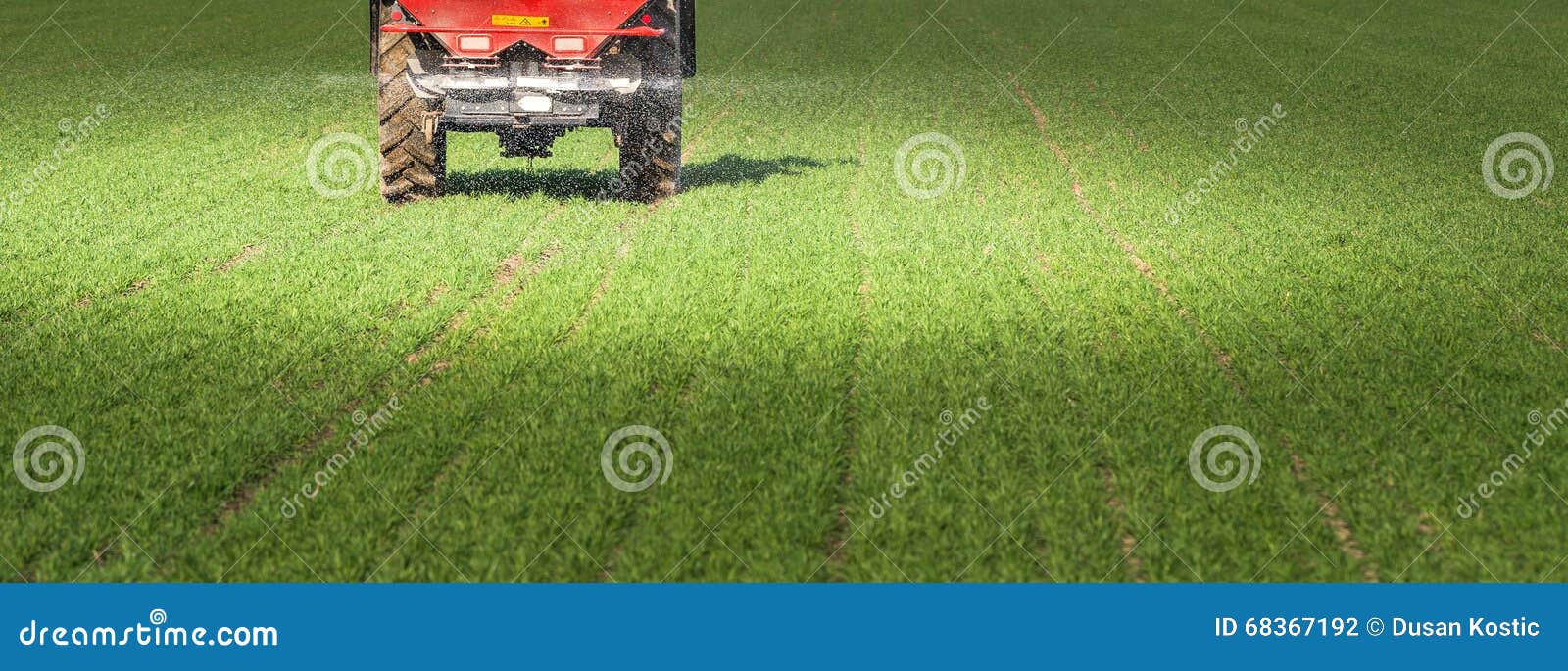 Tractor Fertilizing in Field Stock Photo - Image of equipment ...