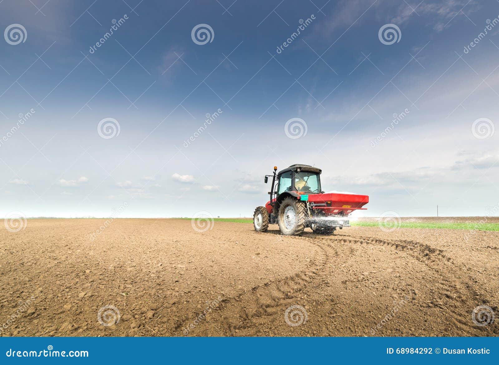 Tractor Fertilizing in Field Stock Photo - Image of tractor, spring ...