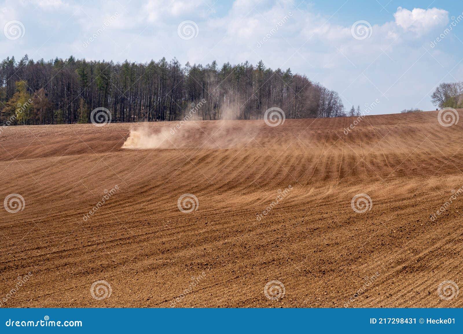 Tractor on the Field with a Lost of Dust because of the Dry Field Stock ...