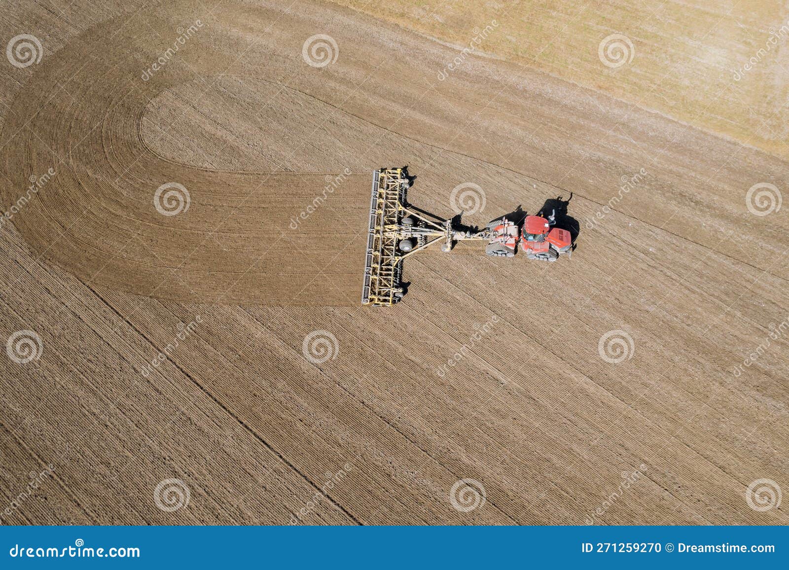 A Tractor in the Field Sows the Ground with Grain. Stock Photo - Image ...