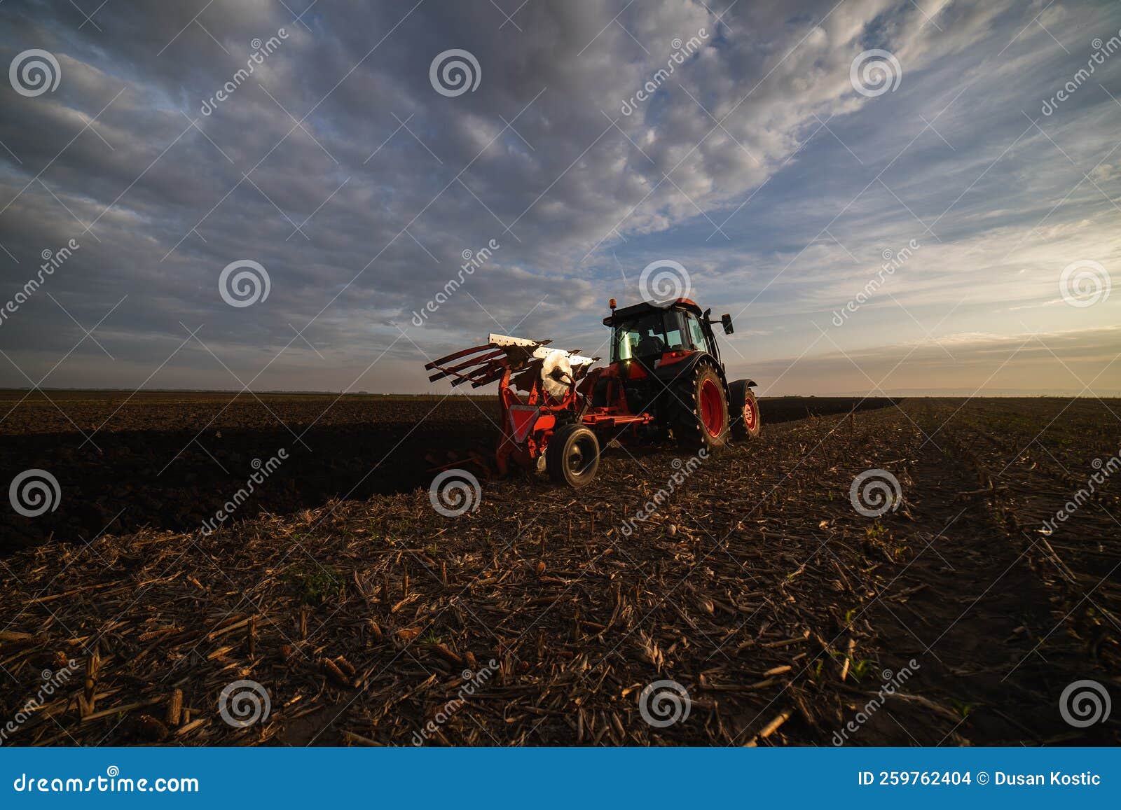 Tractor on the Field during Sunset Stock Photo - Image of machinery ...