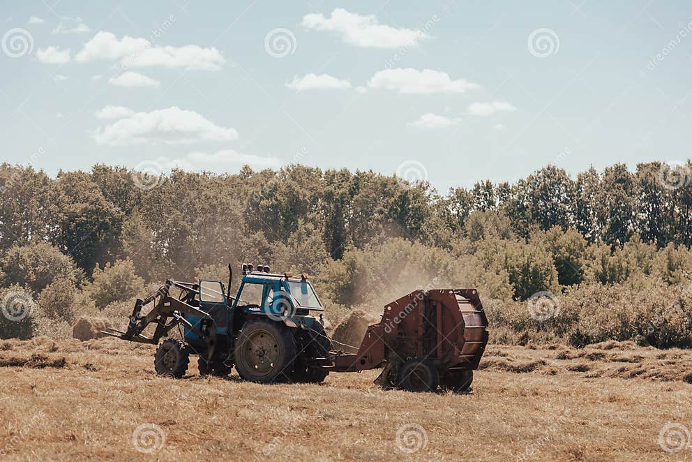 Tractor in Field Throwing Out Hay Roll Stock Image - Image of objects ...