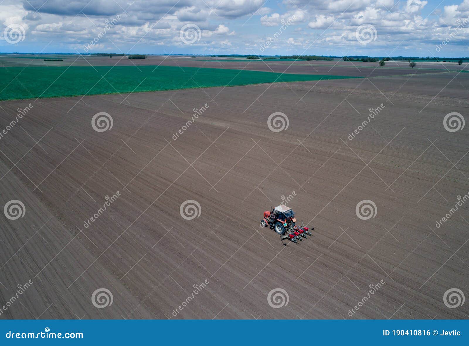 Tractor harrowing field stock photo. Image of agriculture - 190410816