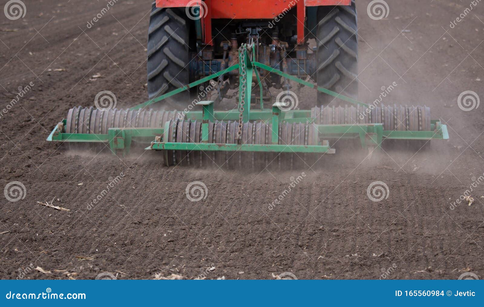 Tractor harrowing soil stock photo. Image of agricultural - 165560984