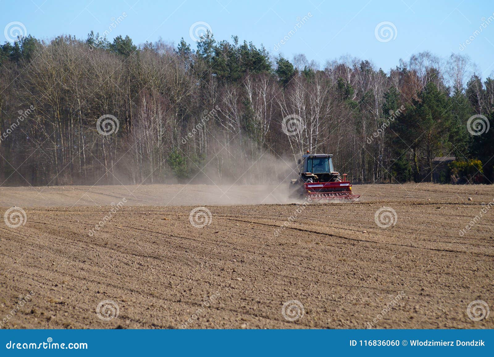The Tractor Harrows Fields for Cultivation. Spring Field Work. Stock ...