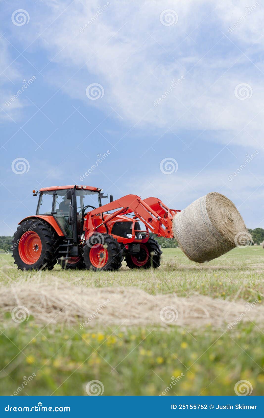 Tractor Hauling Round Bale stock photo. Image of farmland - 25155762