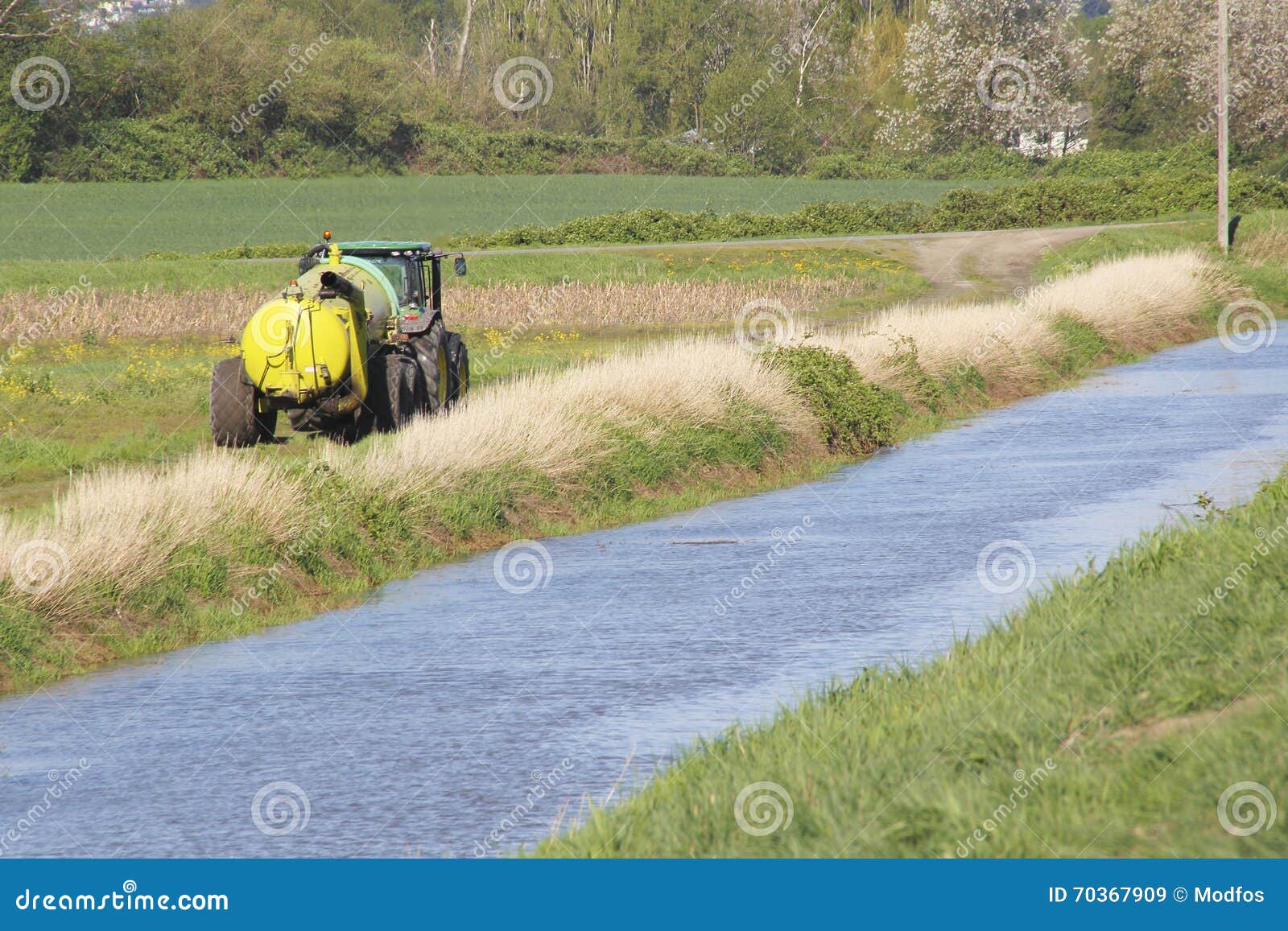 Tractor and Irrigation Water Channel Stock Image - Image of liquid ...