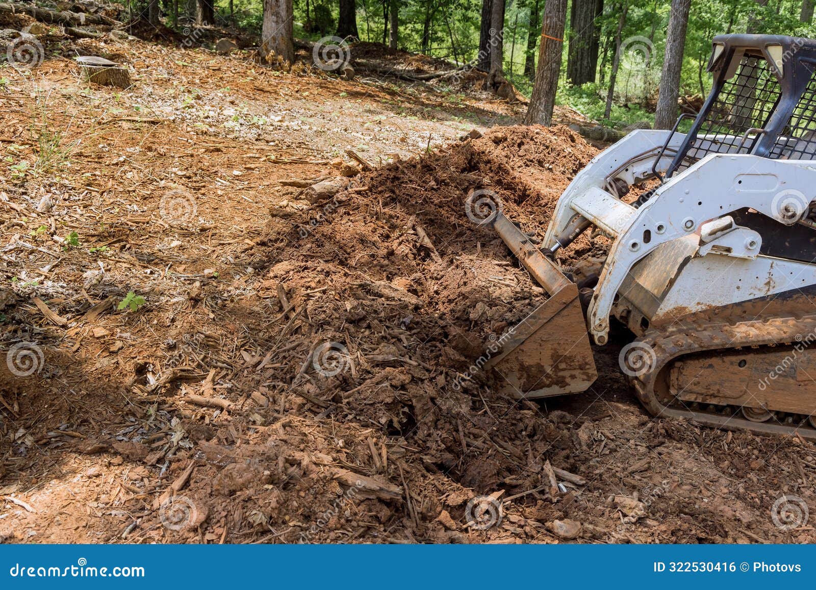 Tractor a Leveling Ground at an Earthmoving Site in Preparation for ...