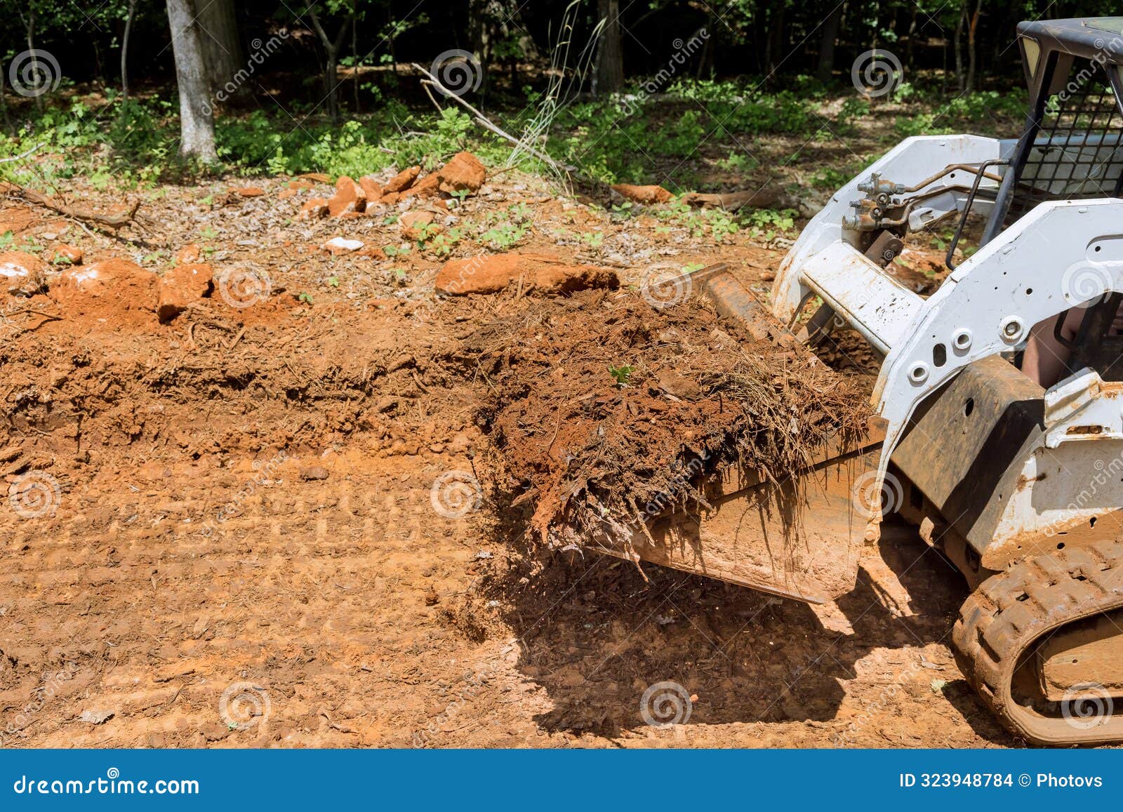 Tractor is Leveling a Ground at Forest during Earthworks Stock Photo ...