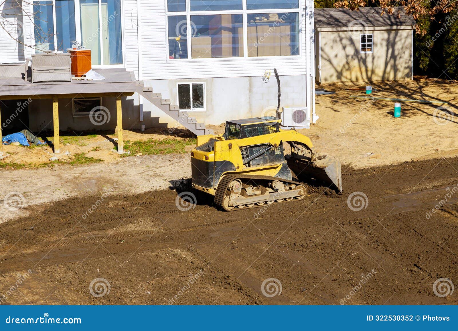 Tractor Levels Ground during Construction Work in a Backyard As Part of ...