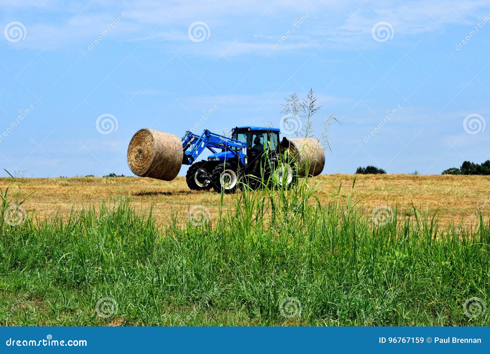 Tractor loading hay bales stock image. Image of outdoors - 96767159