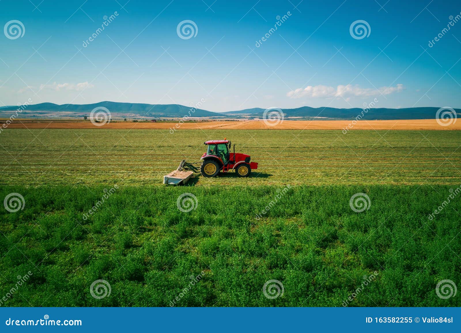 Tractor mowing green field stock image. Image of nature - 163582255