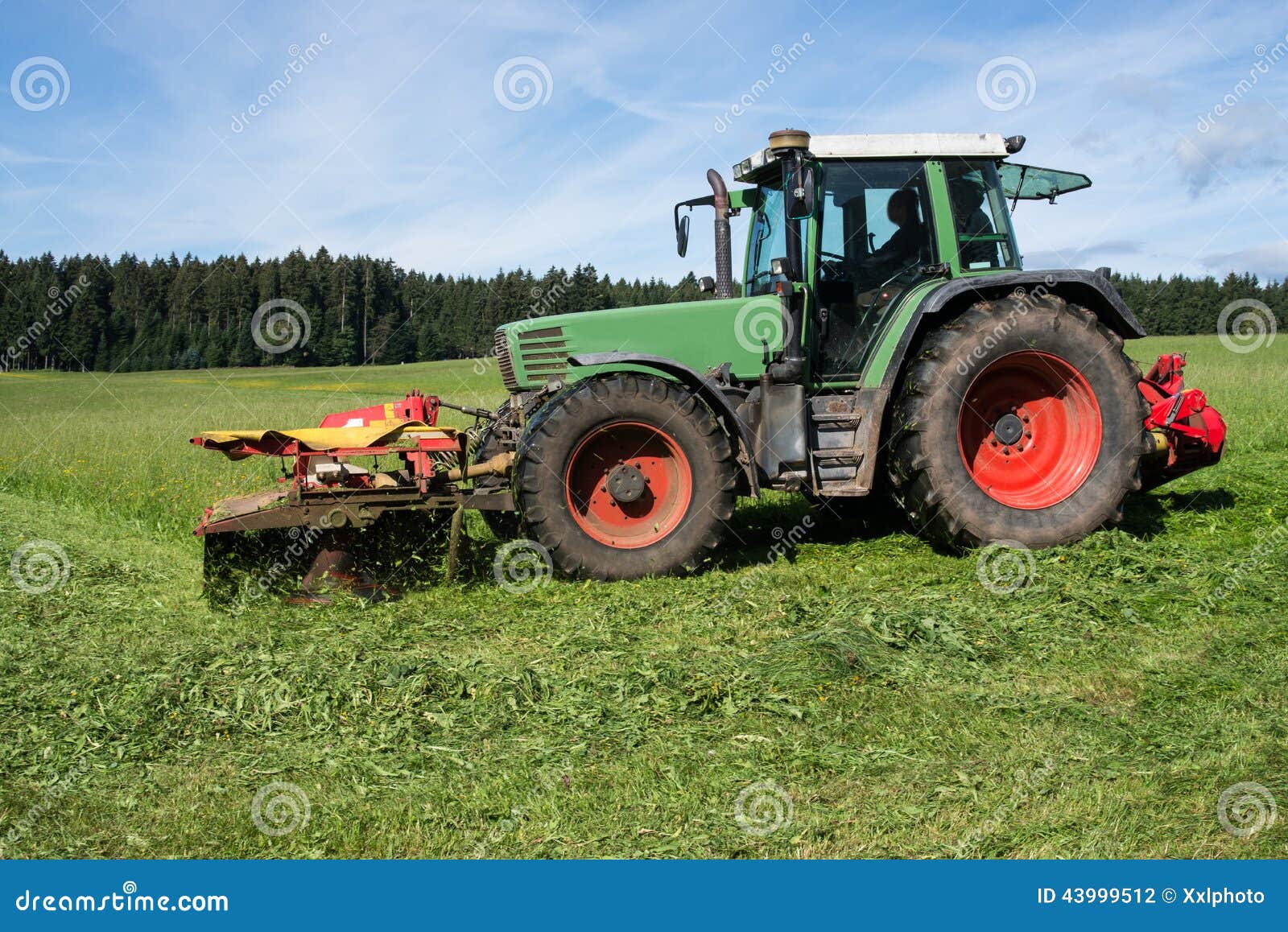 A Man On A Tractor Mowing Hay, Mower Lifted Into Transport Position ...