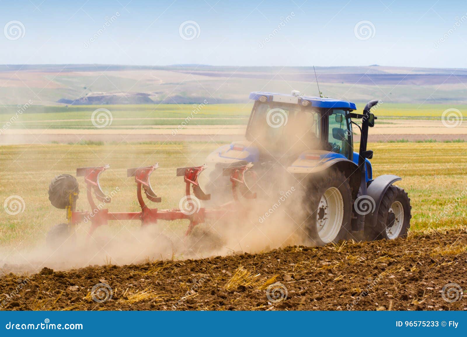 Tractor Ploughing a Field with Trail of Dust Stock Image - Image of ...