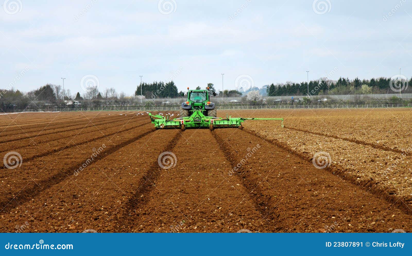 Tractor & Plow Tilling A Field Stock Image - Image: 23807891