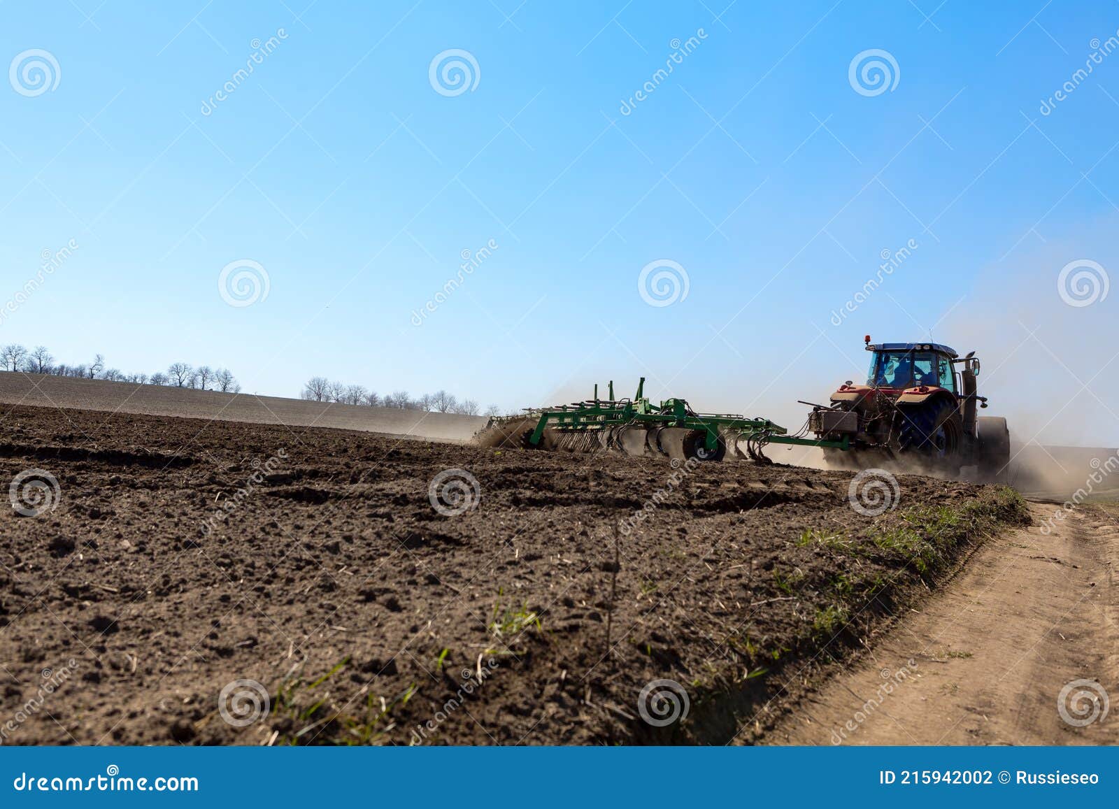 Tractor with Plow Tilling a Field Stock Photo - Image of industrial ...