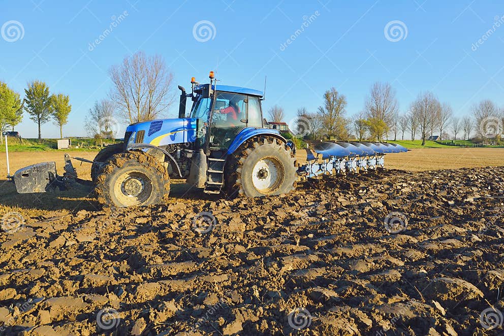 Tractor plowing the field stock image. Image of plowing - 27832381