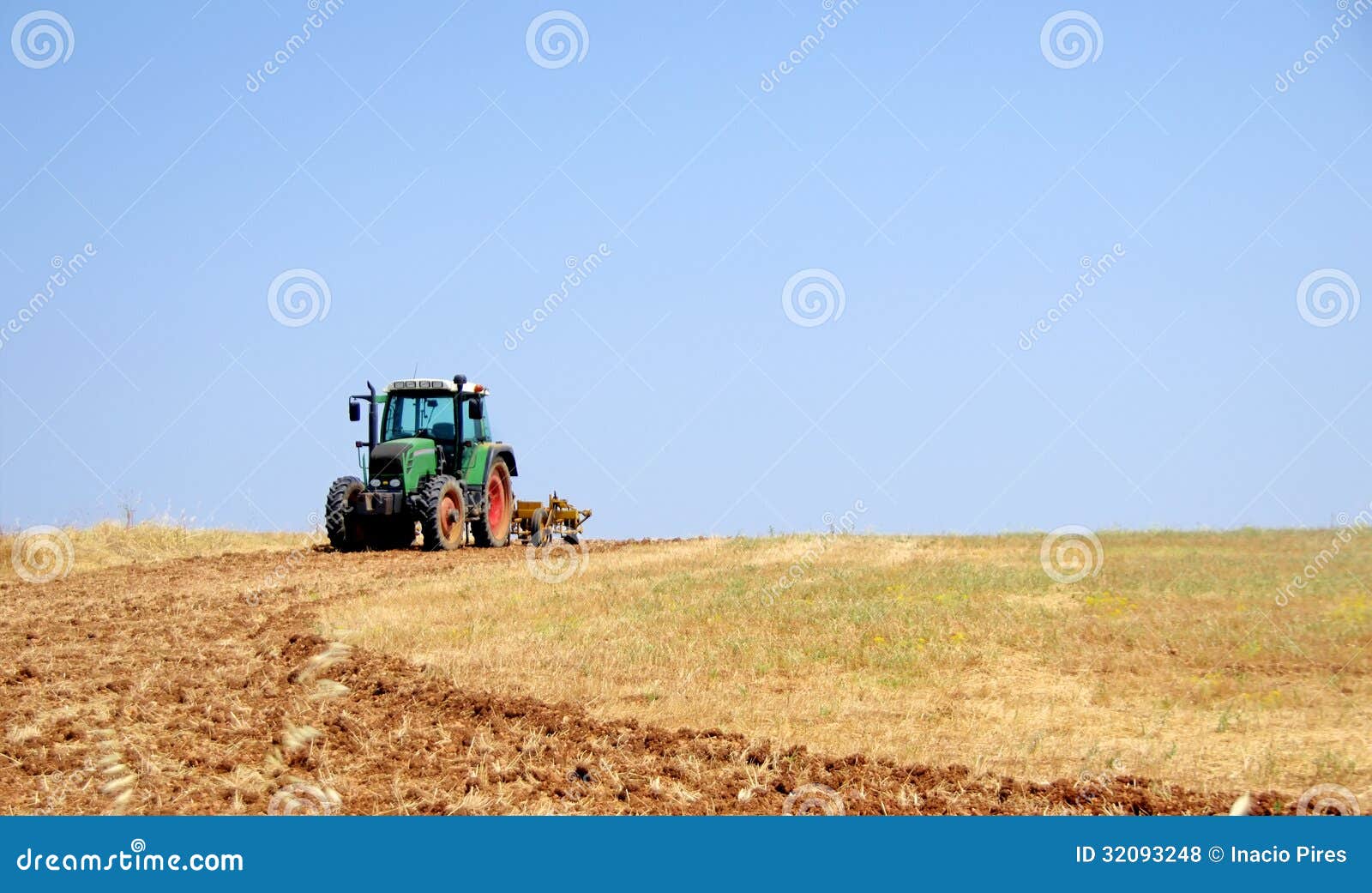 Tractor plowing the field stock photo. Image of machinery - 32093248