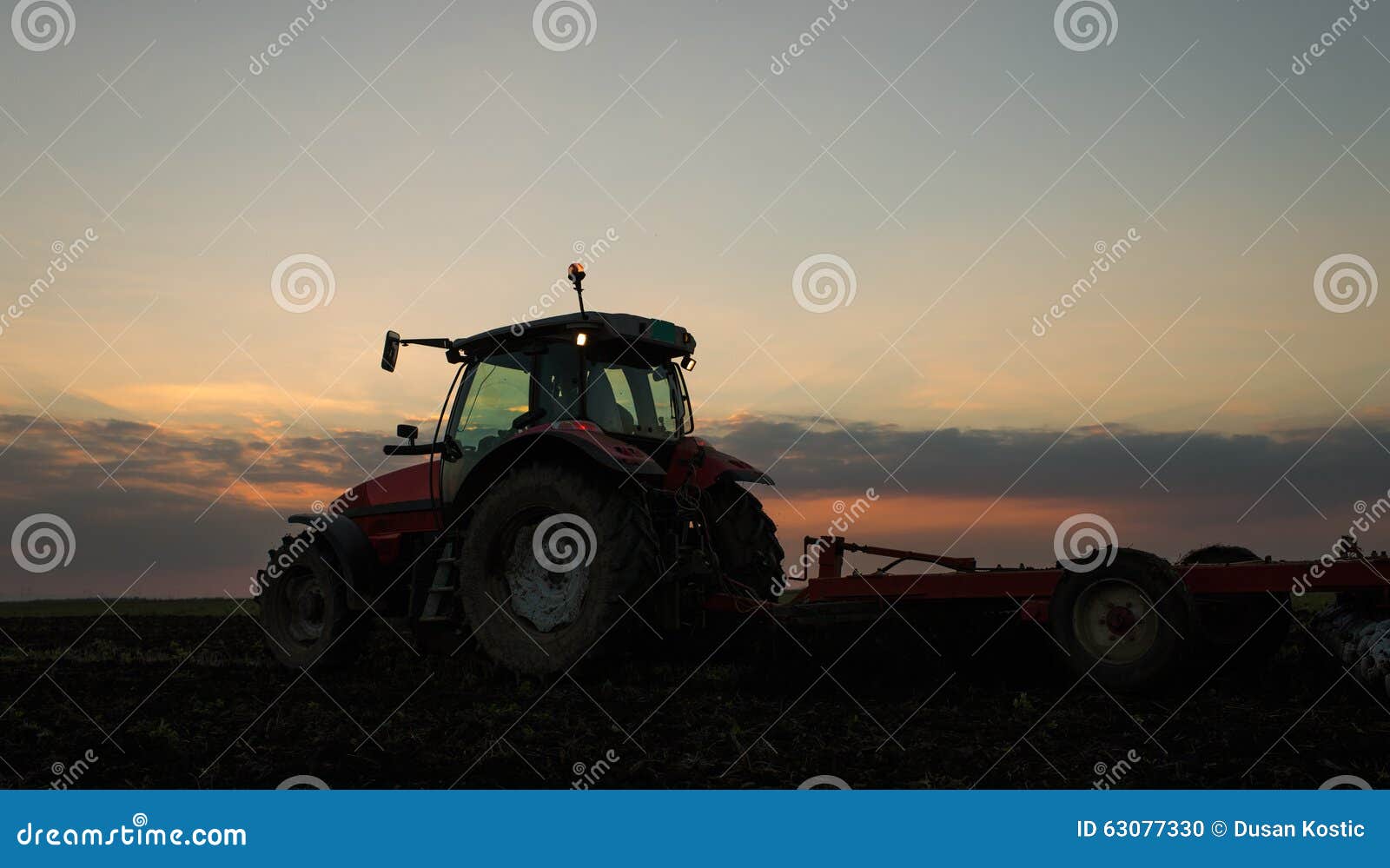 Tractor plowing a field stock photo. Image of land, dusk - 63077330