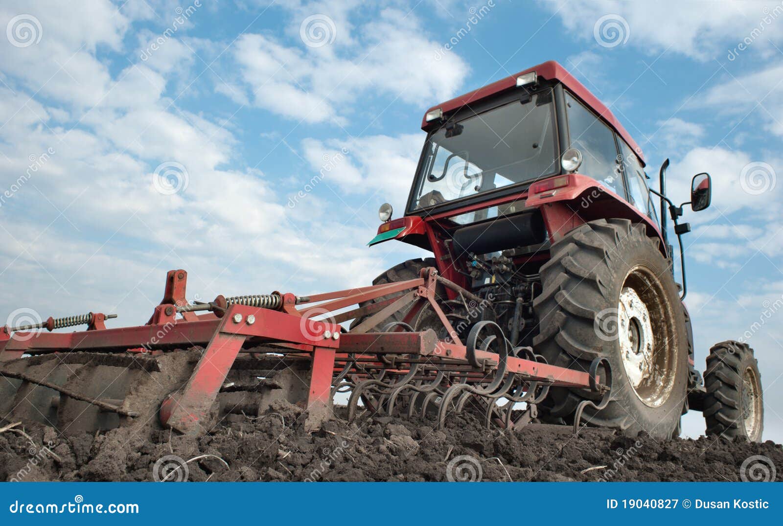 Tractor plowing the fields stock image. Image of cloud - 19040827