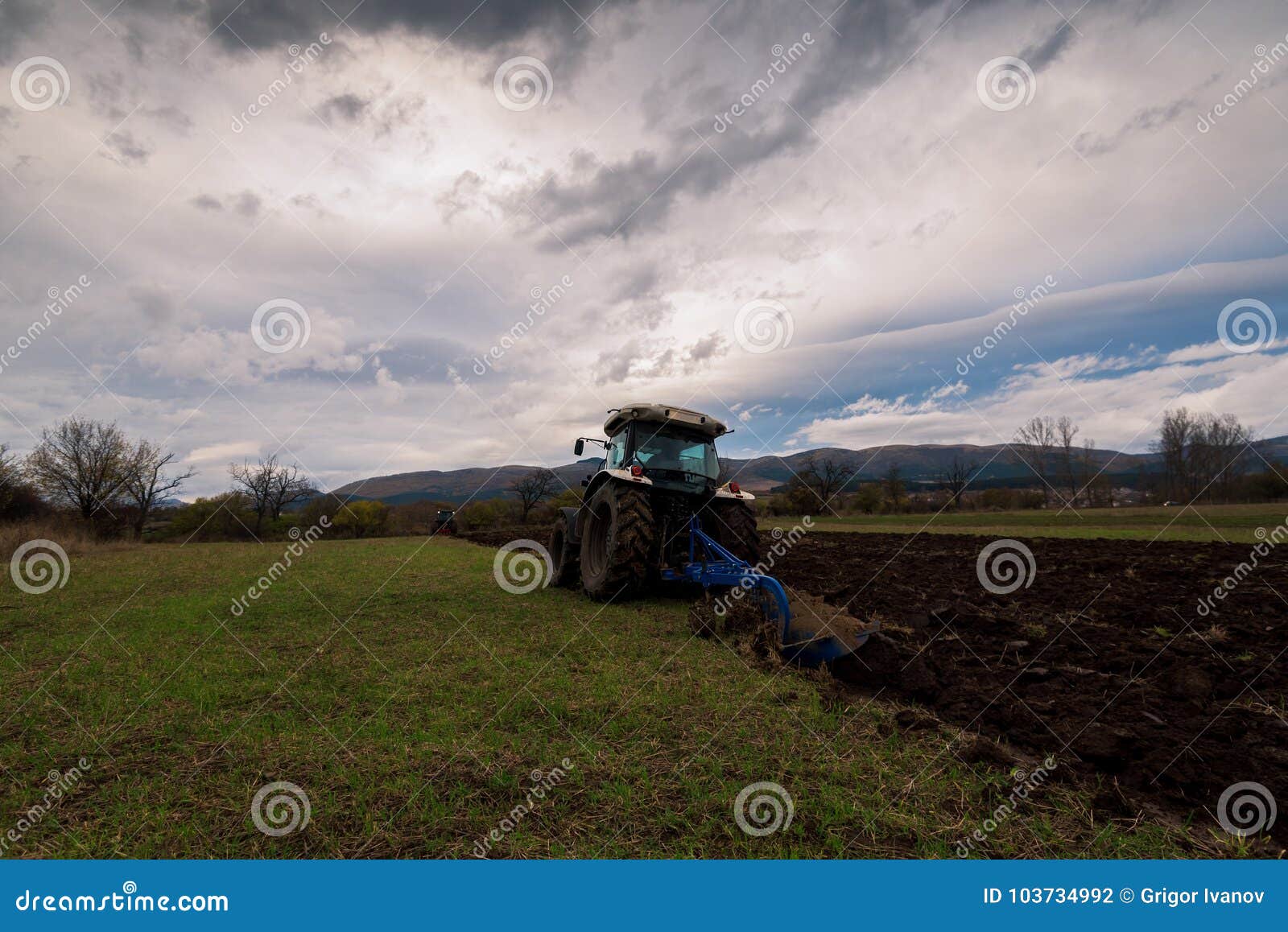 Tractor plowing fields stock photo. Image of autumn - 103734992