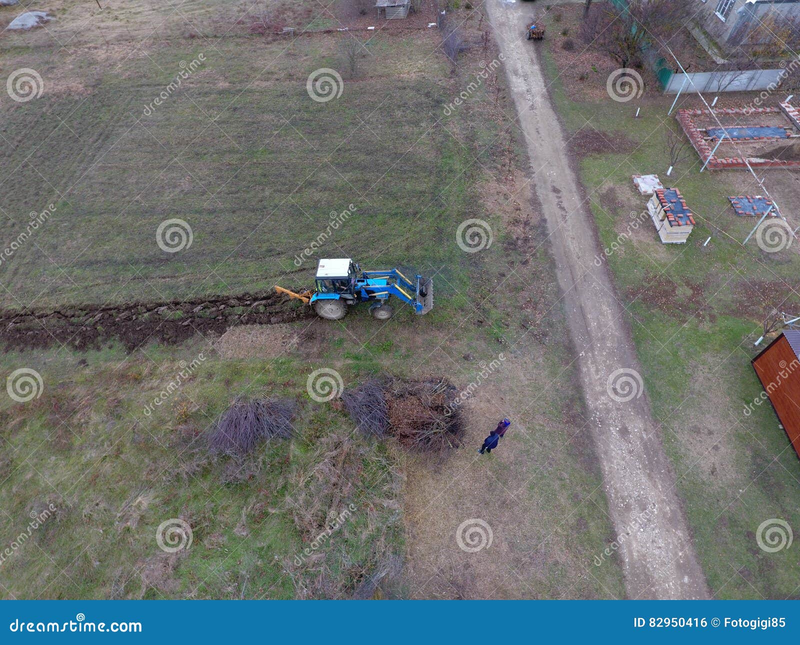 Tractor Plowing the Garden. Plowing the Soil in the Garden Stock Photo ...