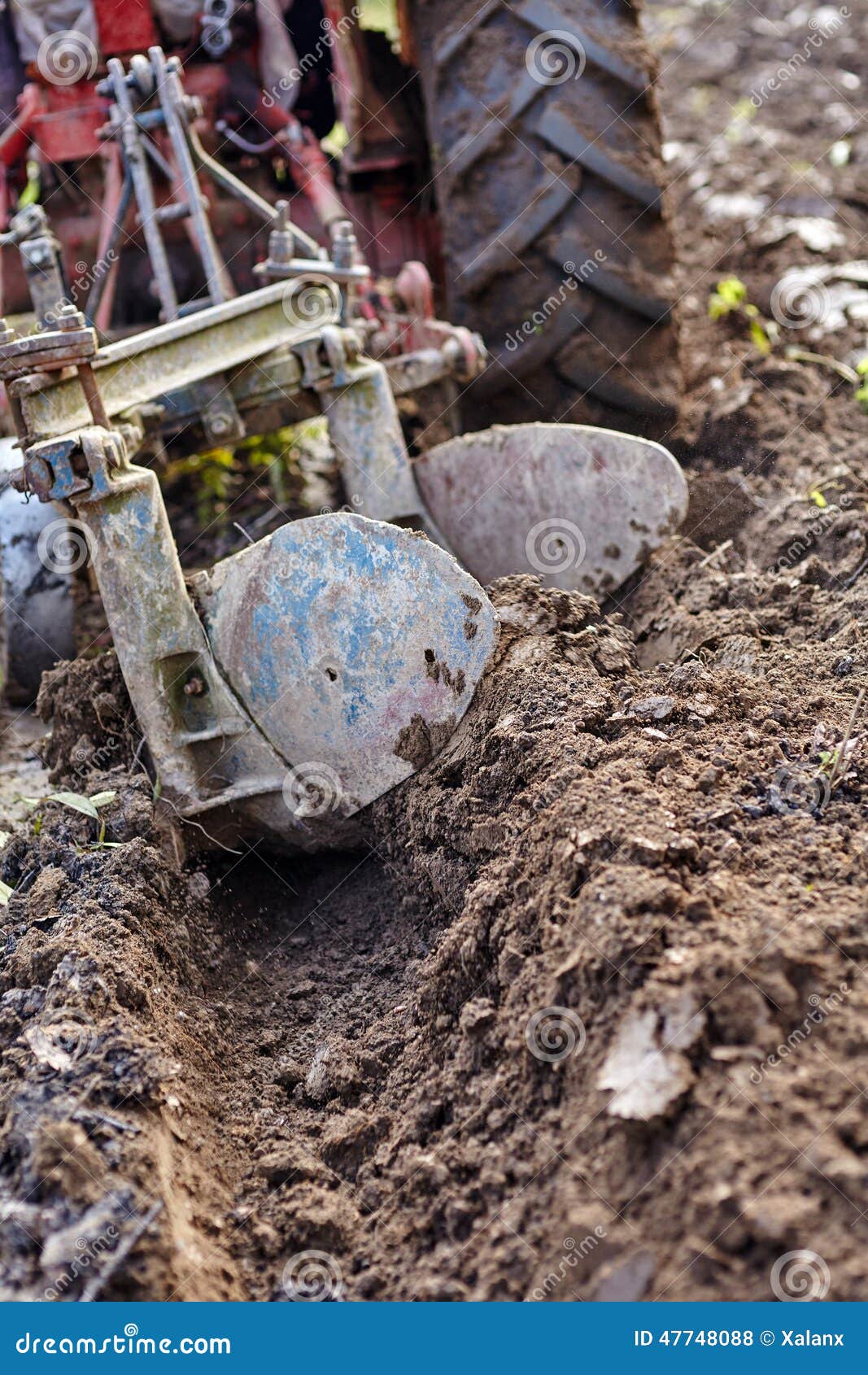 Tractor plowing the land stock photo. Image of action - 47748088
