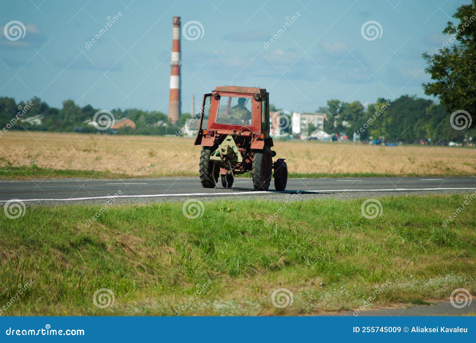 The Tractor Plows the Field Against a Dramatic Sunset Stock Image ...