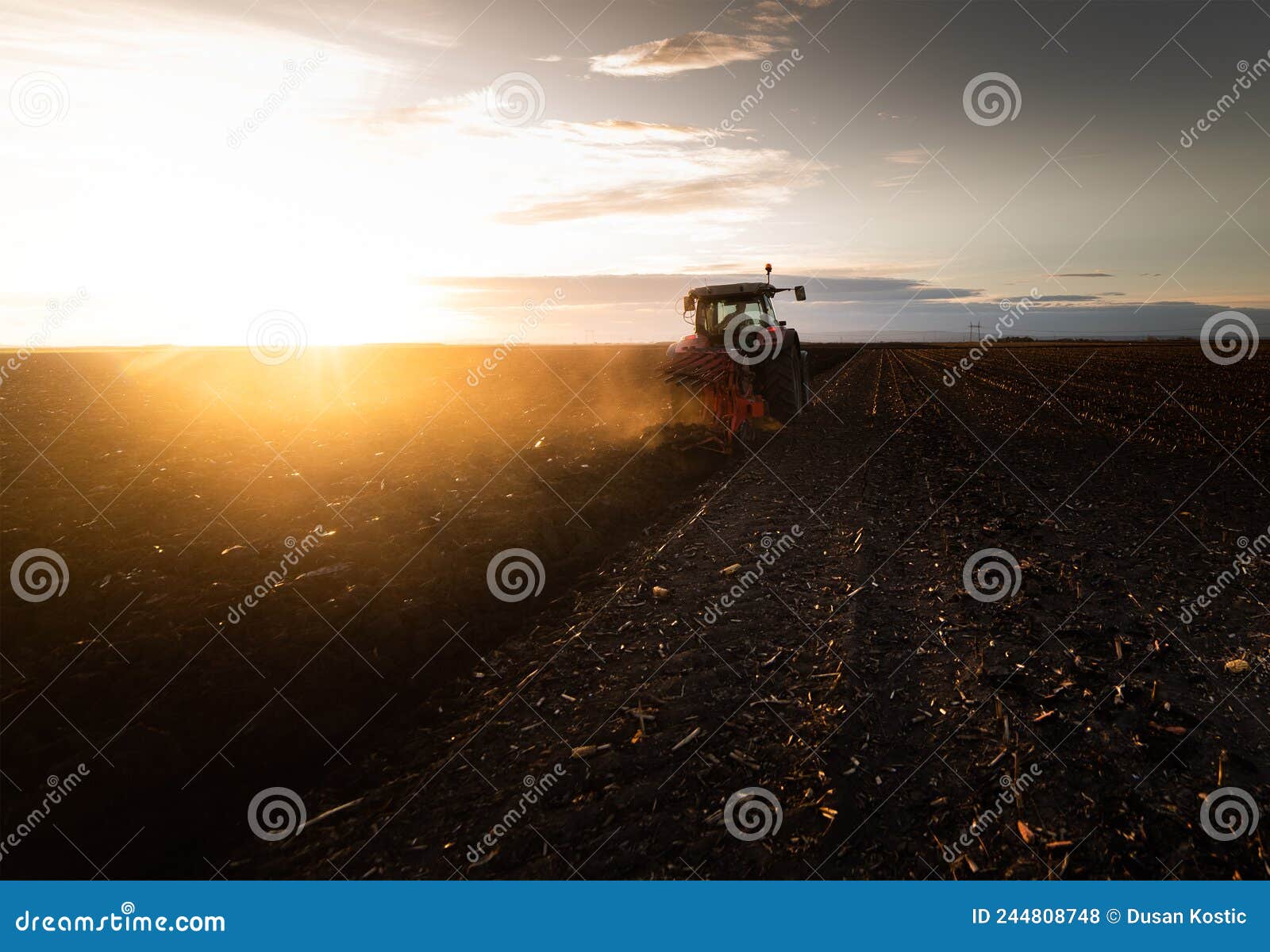 Tractor on the Field during Sunset Stock Photo - Image of view, vehicle ...