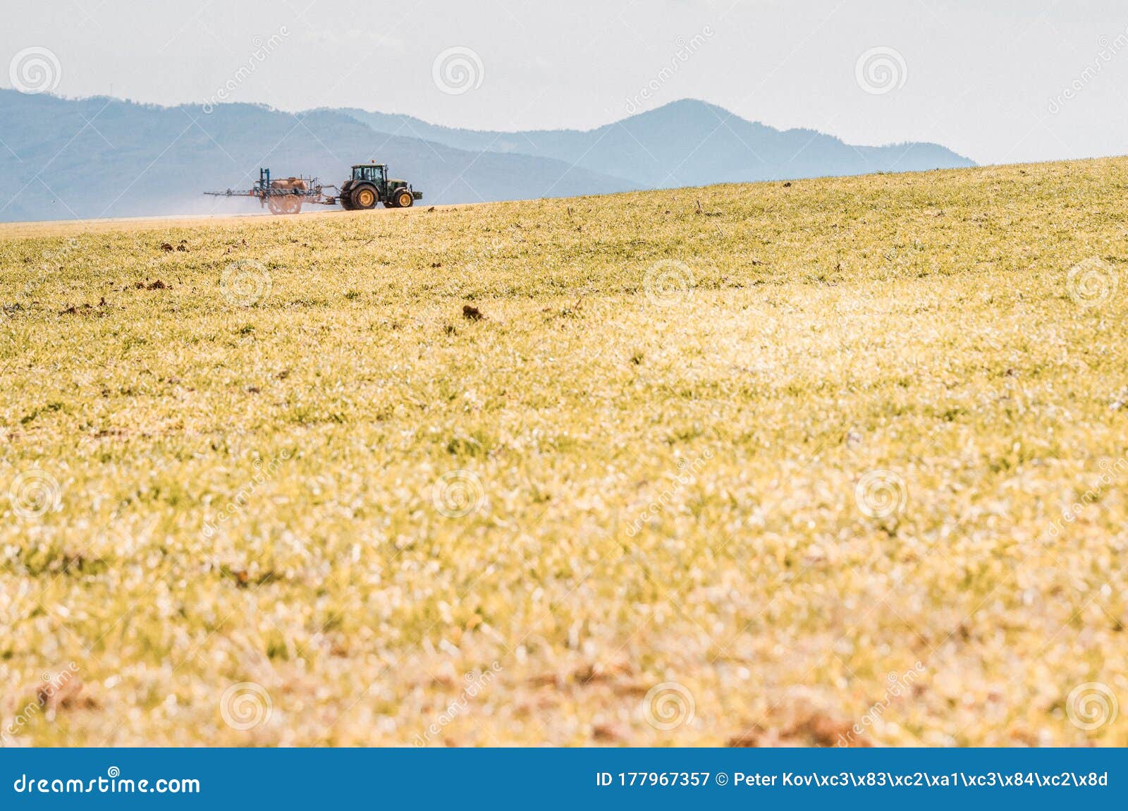Tractor Preparing Spring Agriculture Field and Using Insecticide Which ...