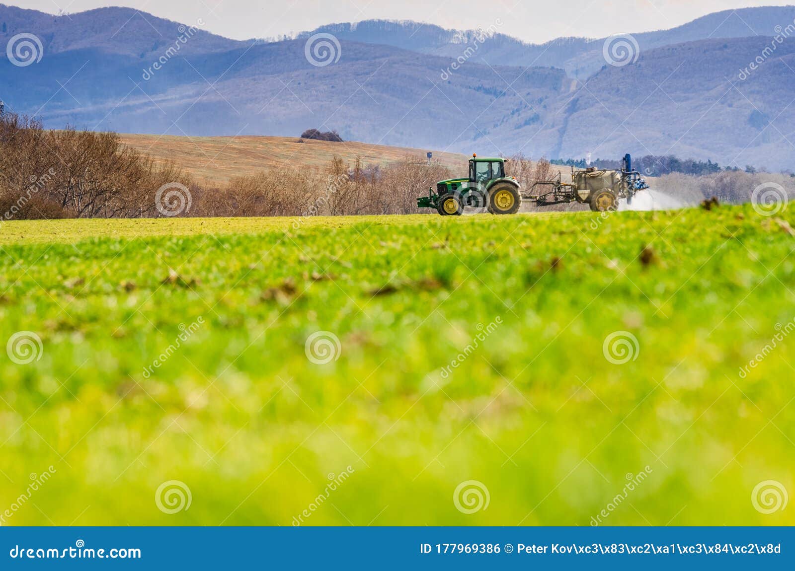 Tractor Preparing Spring Agriculture Field and Using Insecticide Which ...