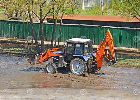 Tractor in a puddle stock image. Image of industrial - 24510675