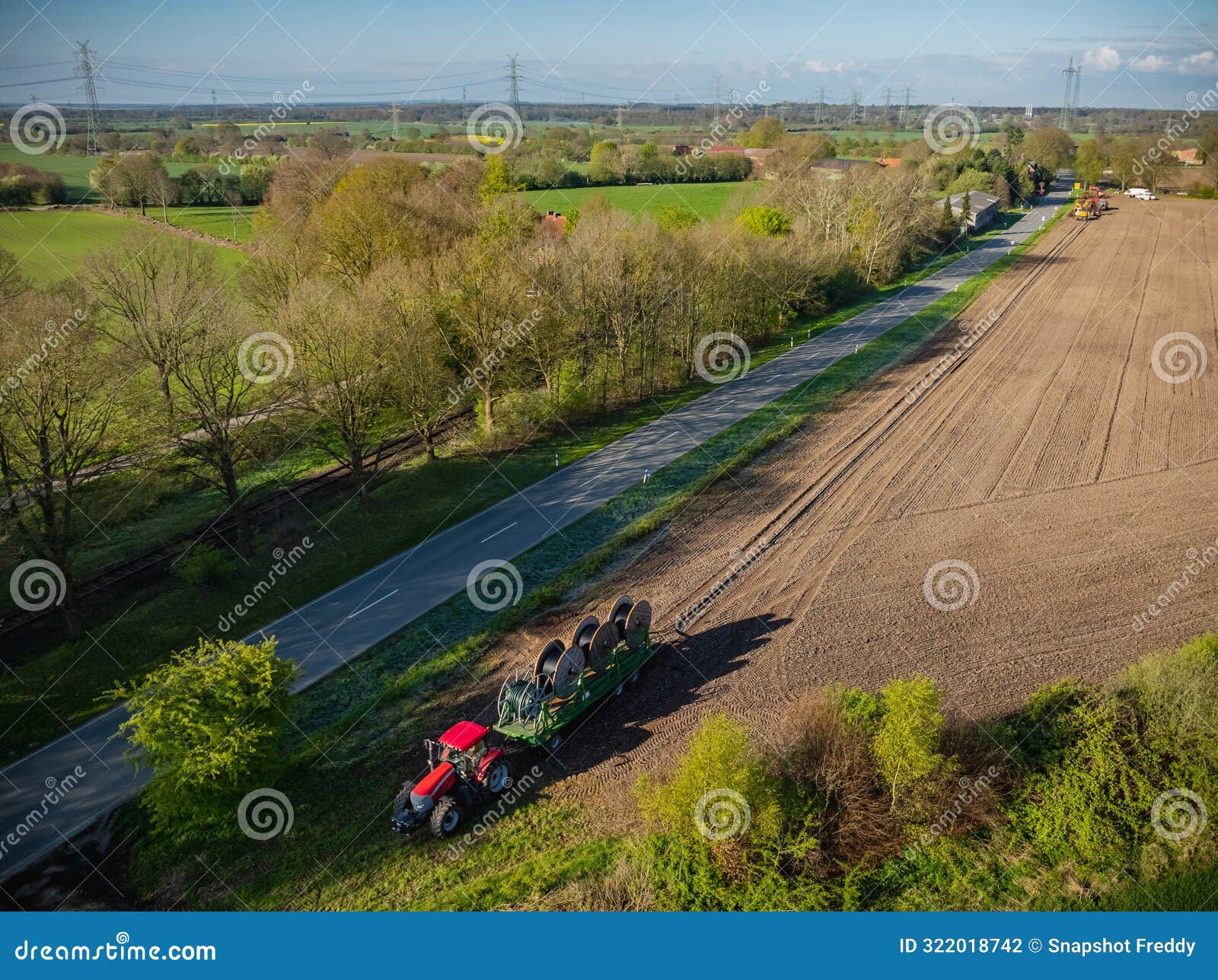 Tractor Pulling a Trailer with Four Wire Spools, Cable Drums. Deploying ...