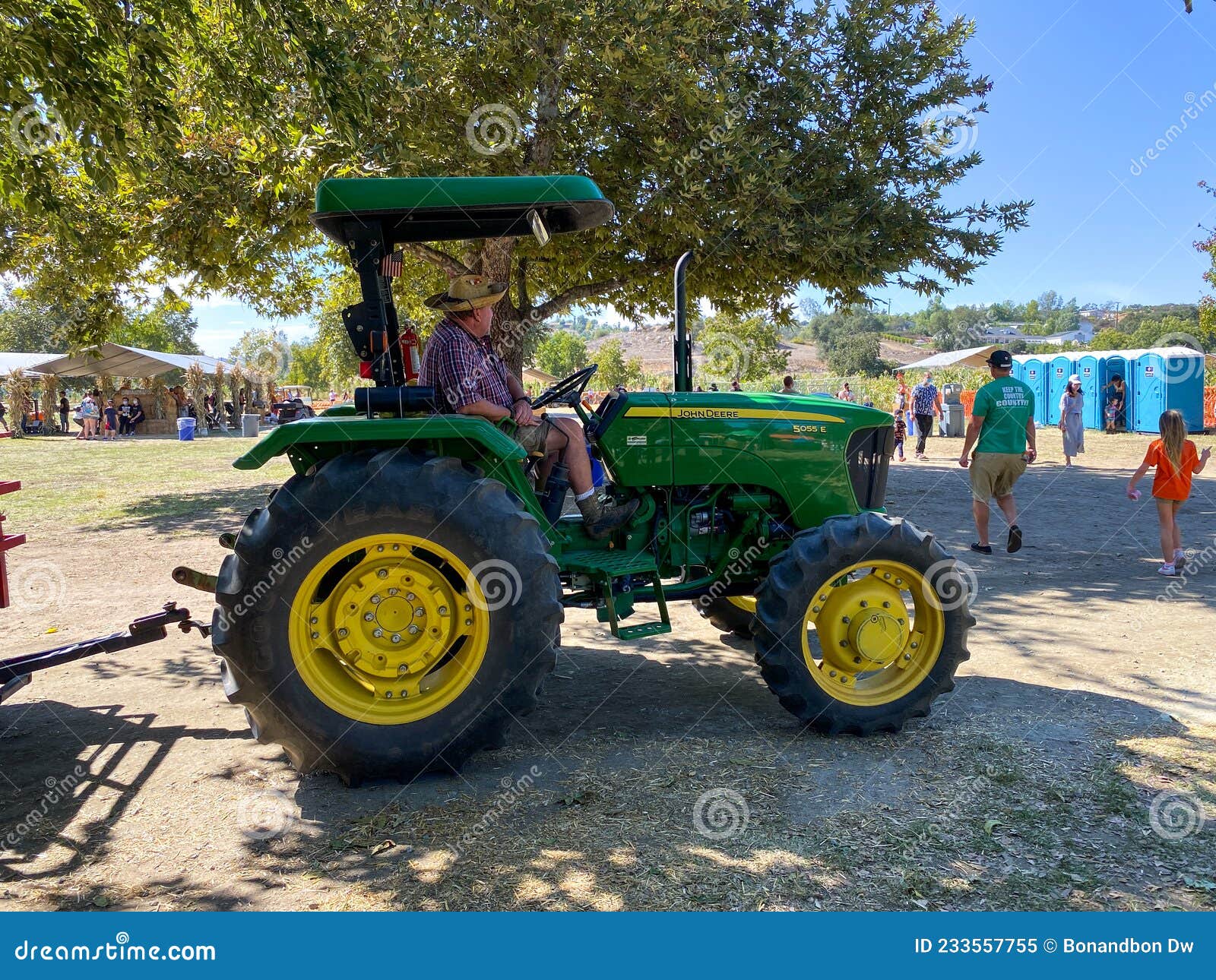A Tractor Pulling a Train of Wagons on a Seasonal Adventures Pumpkin ...