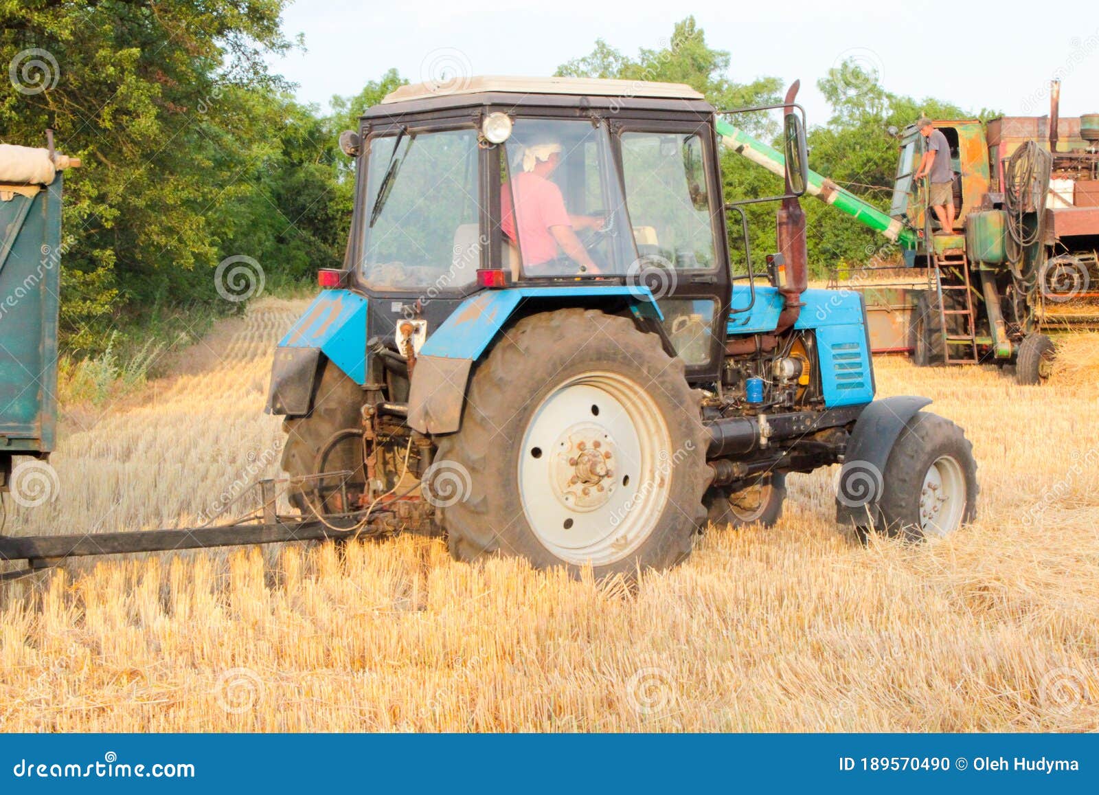 Tractor Pulls Up for Loading To the Combine with Wheat Editorial Image ...