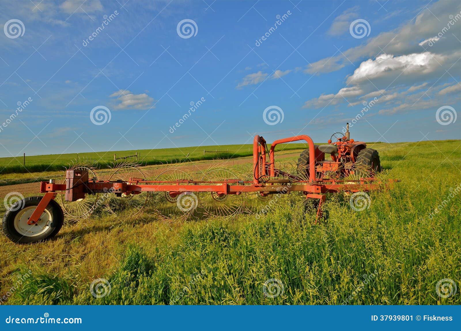 Tractor and Rake Parked in Hay Field Stock Image - Image of parked ...