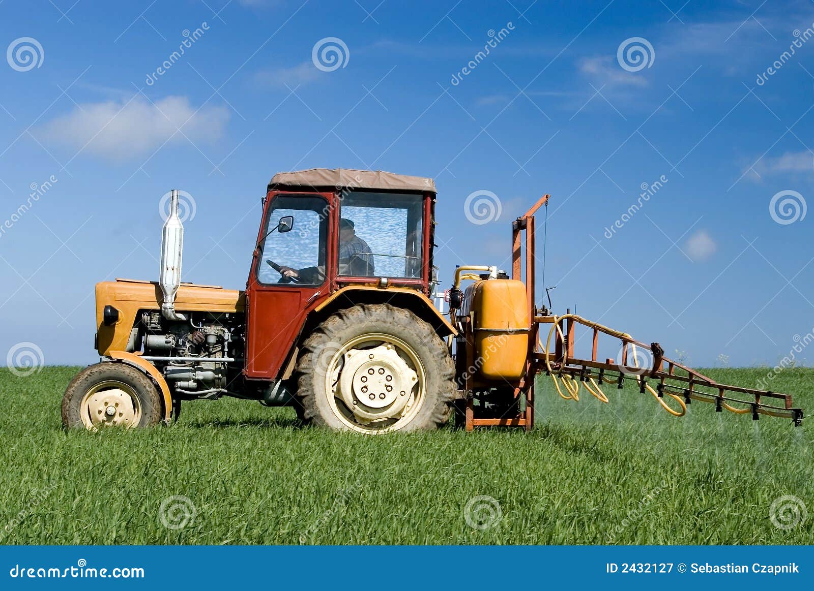 Tractor Spraying Green Field Stock Image - Image of clouds, automation ...