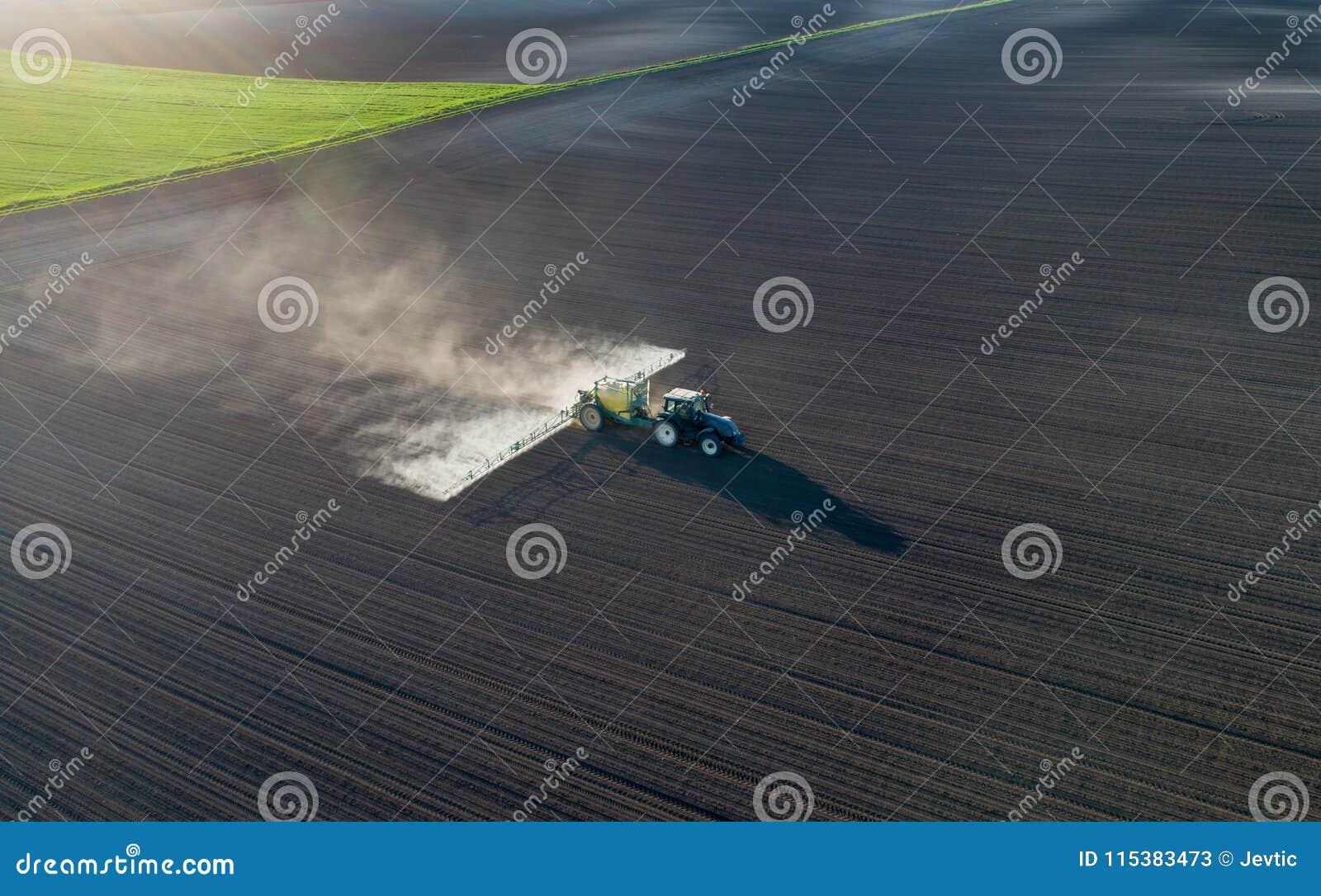 Tractor Spraying Soil in Field Stock Image - Image of evening, farmer ...