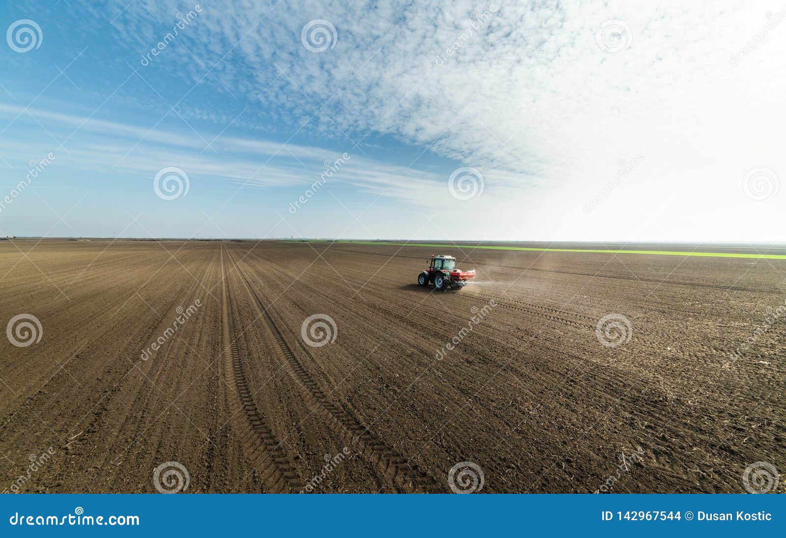 Tractor Spreading Artificial Fertilizers in Field Stock Photo - Image ...