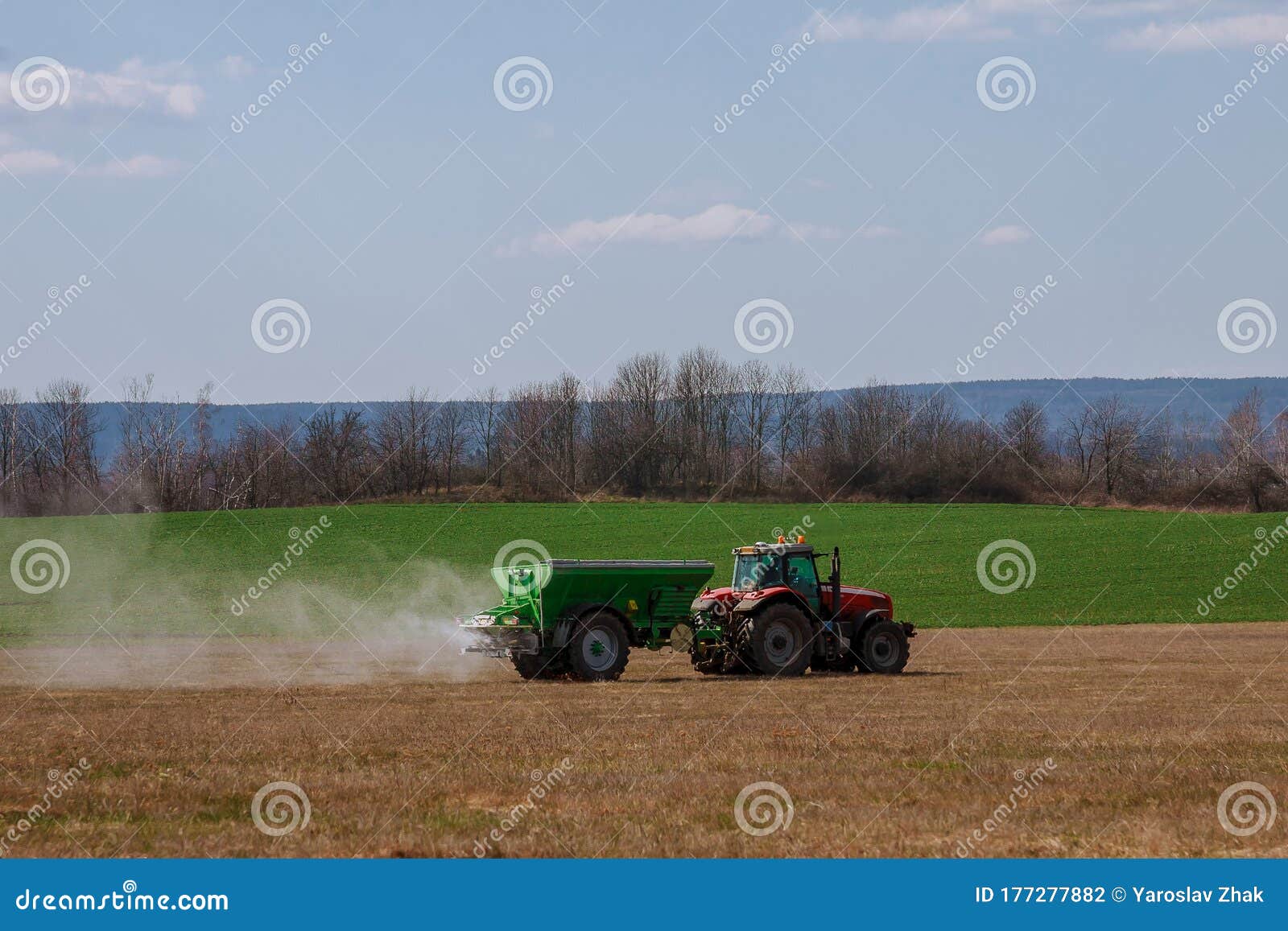 Tractor Spreading Fertilizer on Grass Field. Agricultural Work Stock ...