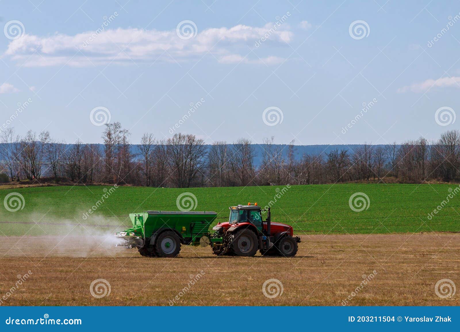 Tractor Spreading Fertilizer on Grass Field. Agricultural Work Stock ...