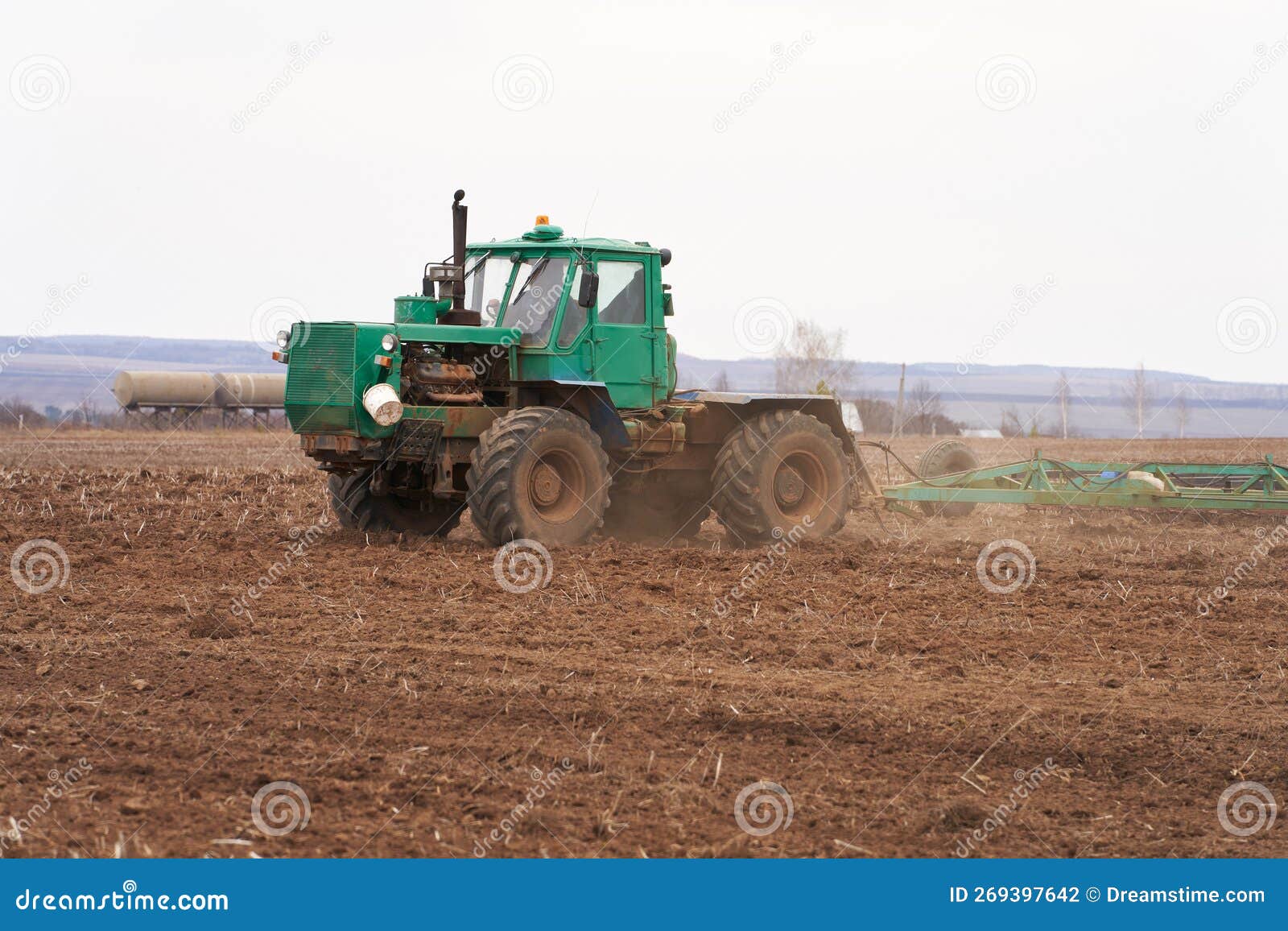 A Tractor With A Trailed Cultivator Prepares The Field For Sowing Grain ...