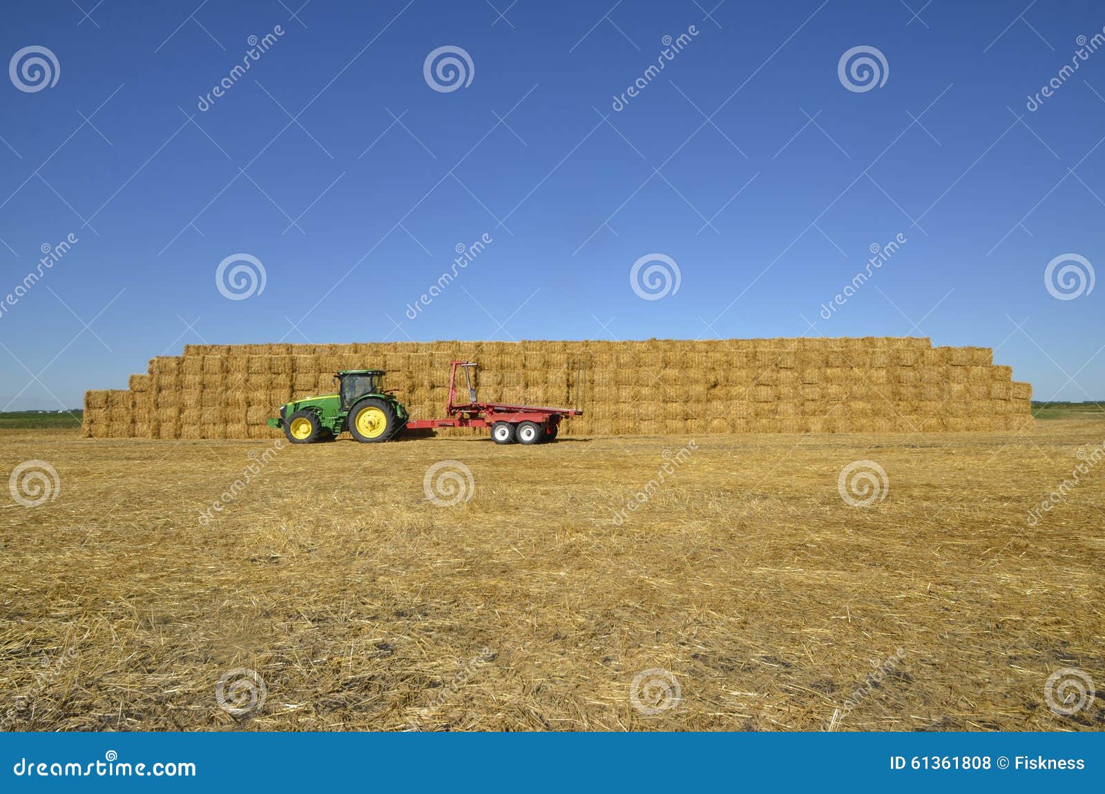 Tractor and Trailer in Front of Stock for Straw Stock Photo - Image of ...