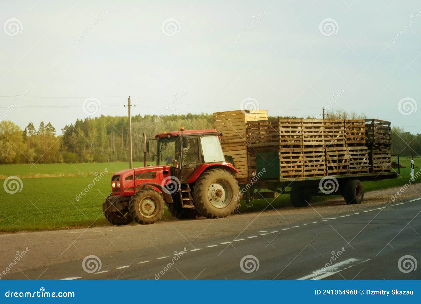 A Tractor Transports Wooden Containers in a Trailer Stock Photo - Image ...