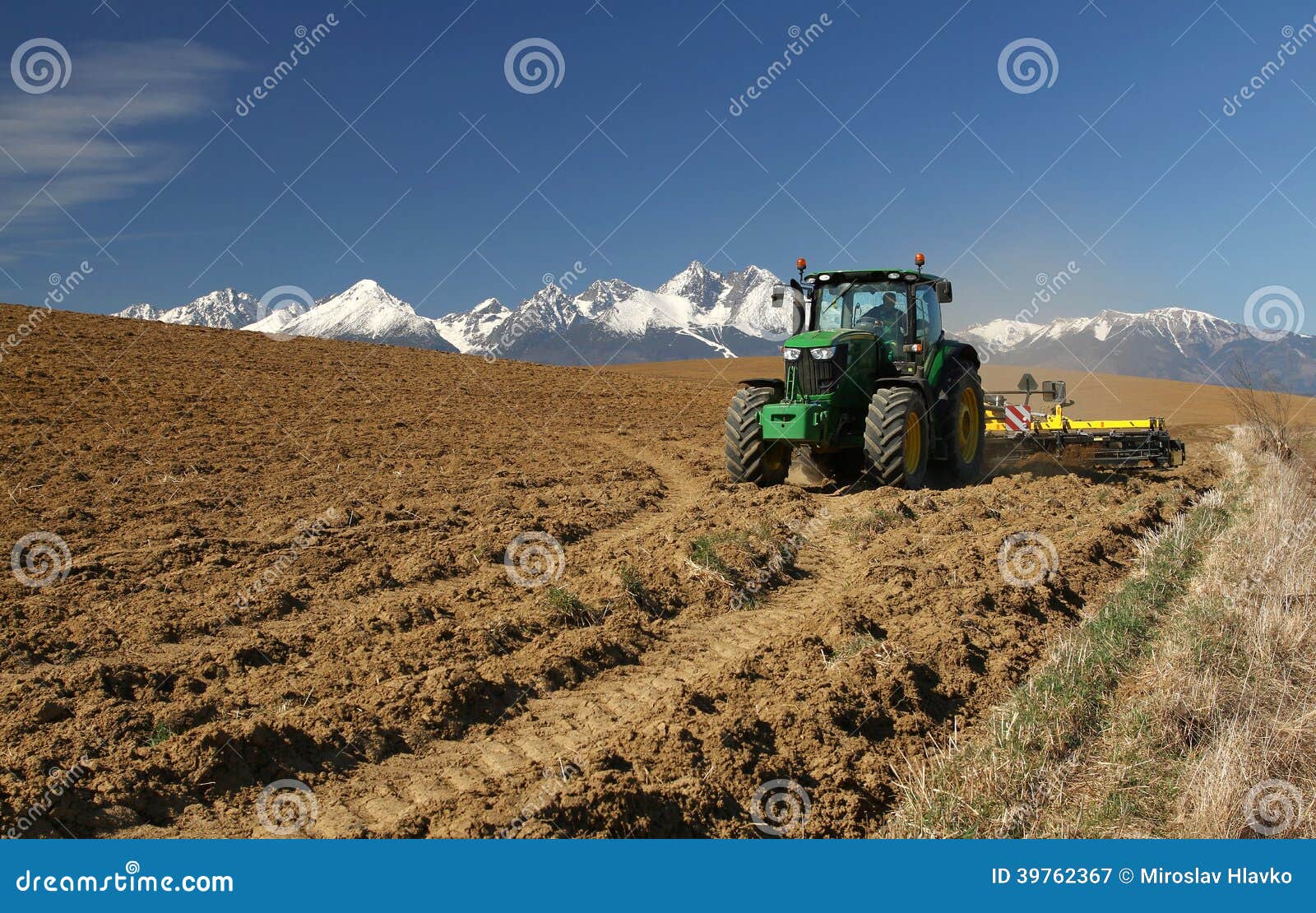 Tractor under mountains stock image. Image of slovakia - 39762367