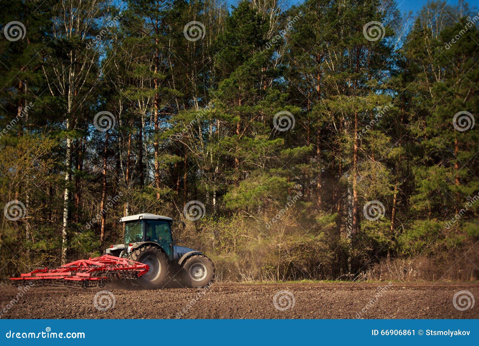 Tractor with Weeding-machine on Edge of Ploughed Field at Forest Stock ...