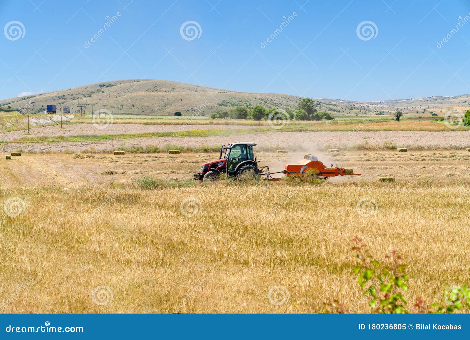 Tractor with Wheat Straw Rectangle Baling Machine Working on a ...